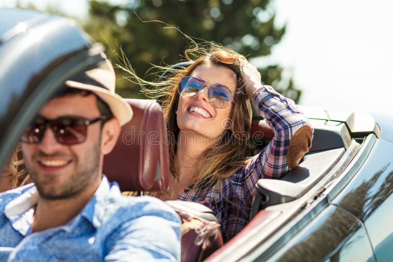 Group of Cheerful Young Friends Driving Car and Smiling in Summer Stock ...