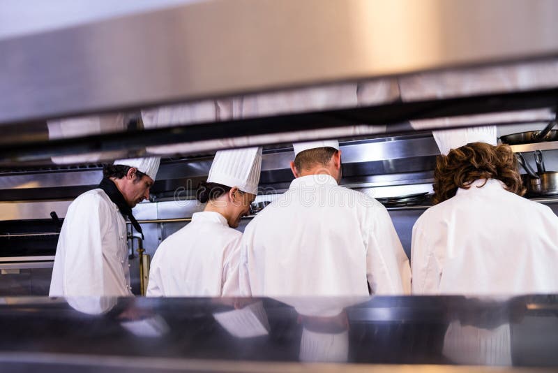 Busy Chefs at Work in the Kitchen Stock Photo - Image of sauce, dish ...