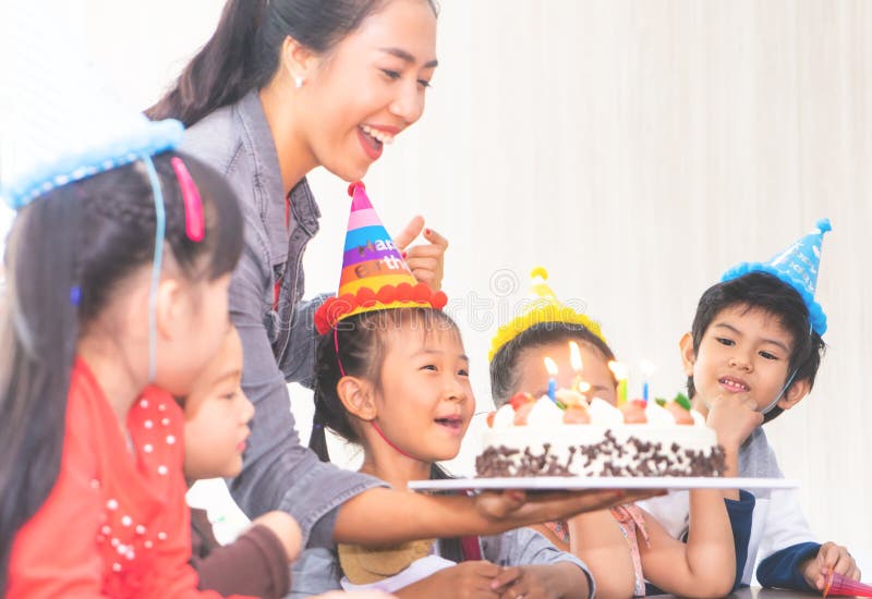 Group of Children Blowing Birthday Cake in Party Stock Image - Image of ...