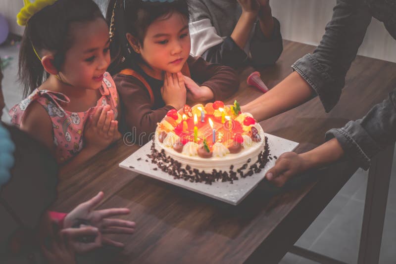 Group of Children Blowing Birthday Cake in Party Stock Image - Image of ...