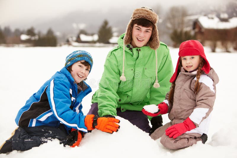 Group of Children Building Snowman Stock Photo - Image of smiling, male ...