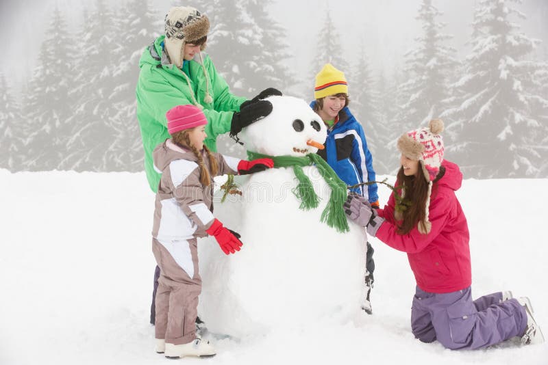 Group of Children Building Snowman on Ski Holiday Stock Image - Image ...
