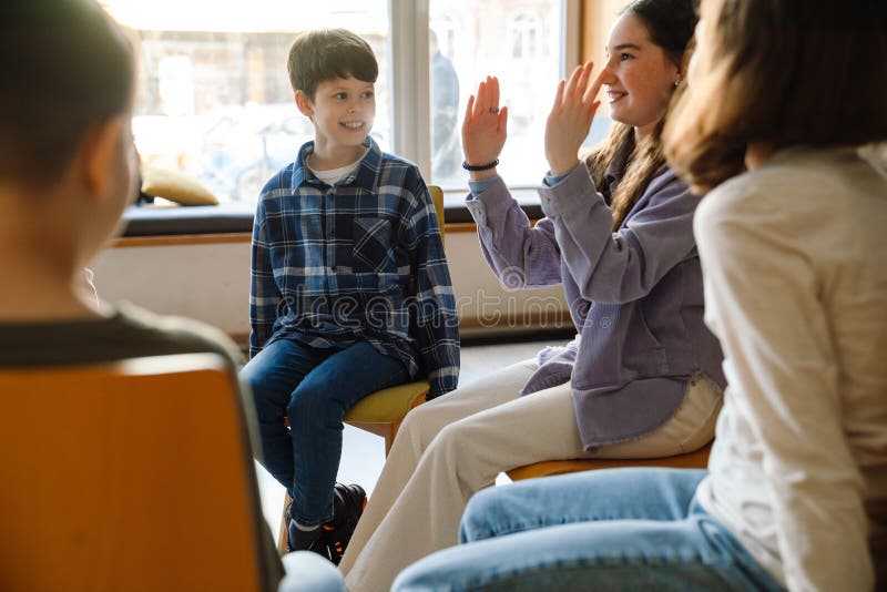 Group of Children Discussing Something while Sitting in Classroom Stock ...