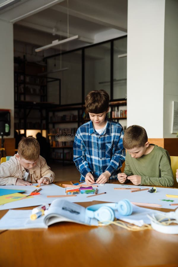 Group of Children Drawing during Art Lesson in Library Stock Photo ...