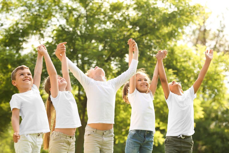 Group of Children Holding Hands Up in Park Stock Photo - Image of park ...