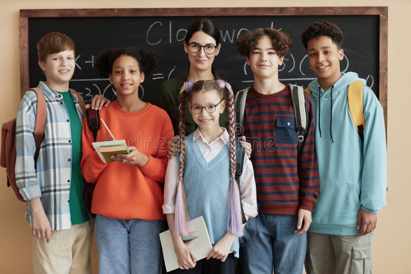 Group of Children Looking at Camera Standing by Blackboard Stock Photo ...