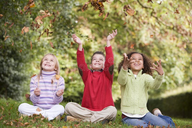 Group of Children Playing in Autumn Leaves Stock Image - Image of ...