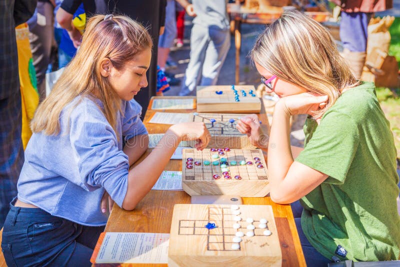 A Group of Children Playing the Board Logic Game `the Mill` in the Park ...