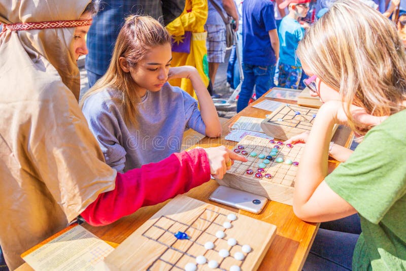 A Group of Children Playing the Board Logic Game `the Mill` in the Park ...