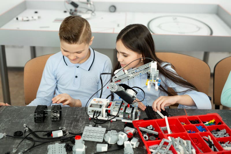 Group of Children are Playing with Robots Assembled from Plastic Parts ...