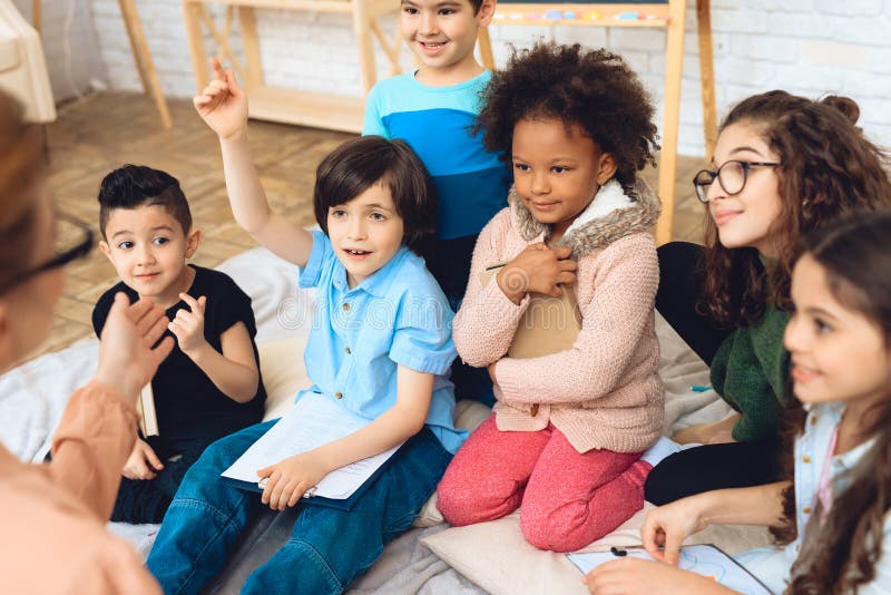 Group of Children are Pulling Hands To Answer Teacher`s Question in ...