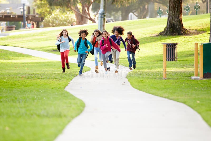 Group of Children Running Along Path Towards Camera in Park Stock Image ...