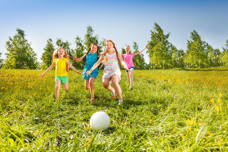 Group of Children Running To the Ball in Meadow Stock Image - Image of ...