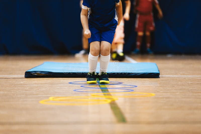 Group of Children in School Age Jumping Over Obstacles at Indoor ...