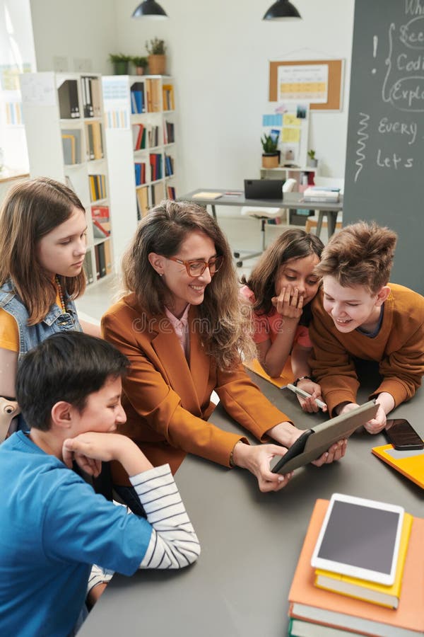 Group of Children with Smiling Teacher Looking at Tablet Stock Image ...