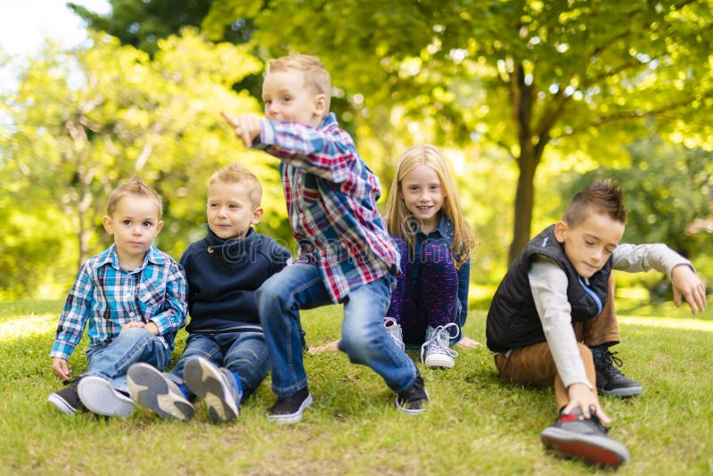 A Group of Children in Spring Field Having Fun Stock Image - Image of ...
