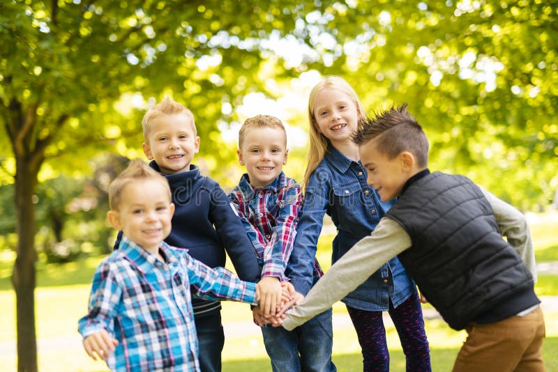 A Group of Children in Spring Field Having Fun Stock Image - Image of ...