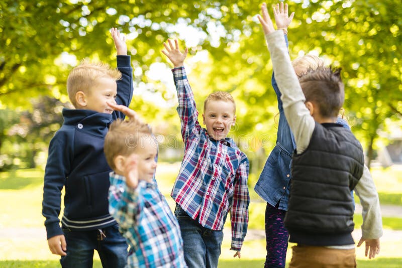 A Group of Children in Spring Field Having Fun Stock Photo - Image of ...