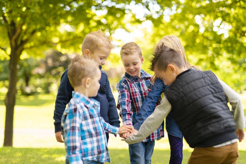 A Group of Children in Spring Field Having Fun Stock Photo - Image of ...