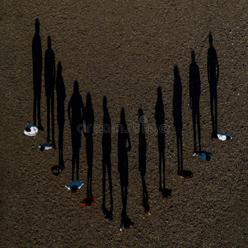 A Group of Children Stand on the Road, Resulting in Shadows, Top View ...