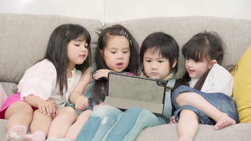 Group of Children Using Tablet in Classroom, Multi-ethnic Young Boys and Girls Happy Using ...