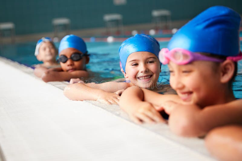 Group of Children in Water at Edge of Pool Waiting for Swimming Lesson ...