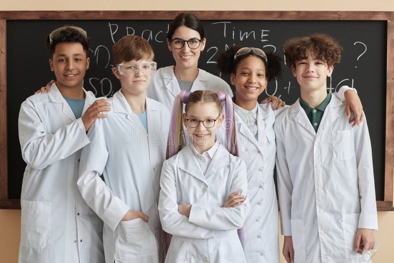 Group of Children Wearing Lab Coats in Science Class at School Smiling ...
