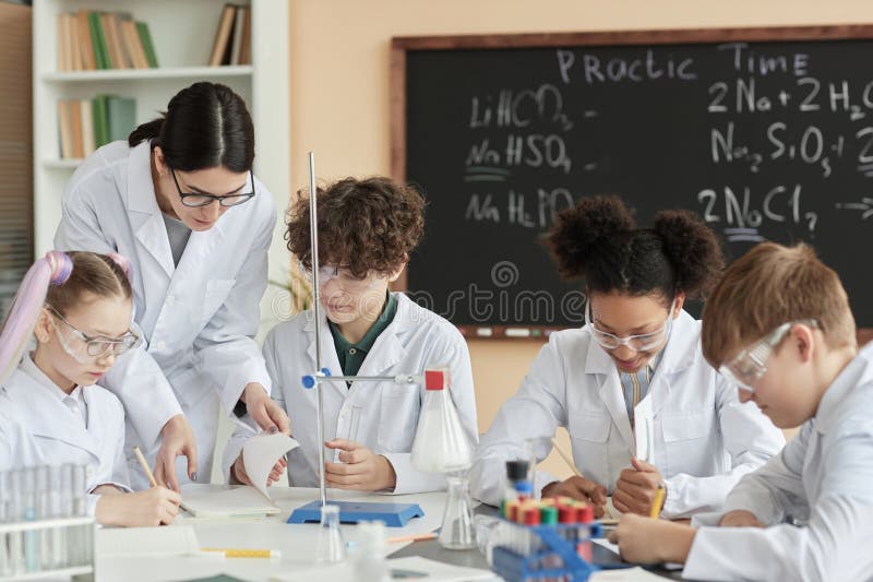 Group of Children Wearing Lab Coats in Science Class at School Teacher ...