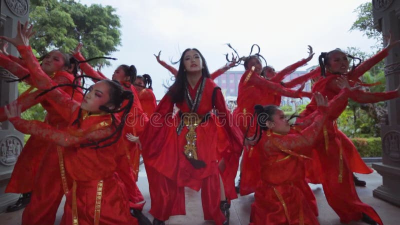 A Group of Chinese Women Dancing with the Stick while Wearing Red ...