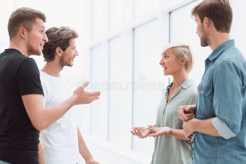 Group of Co-workers are Discussing Something in the Office Corridor ...
