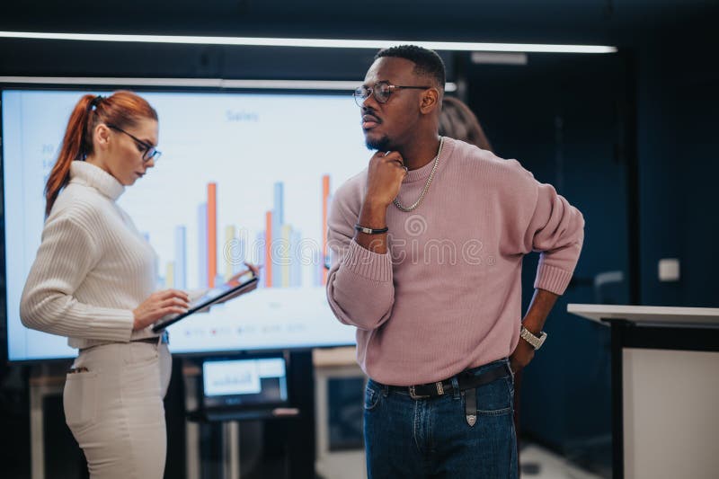 Group of Colleagues Collaborating on Analyzing Statistics and ...