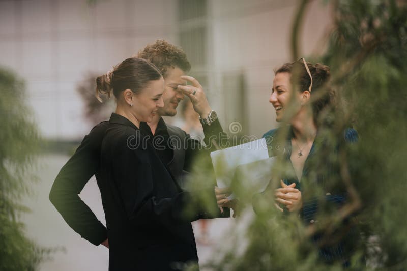 Group of Colleagues Laughing and Discussing Work Outdoors in a Friendly ...