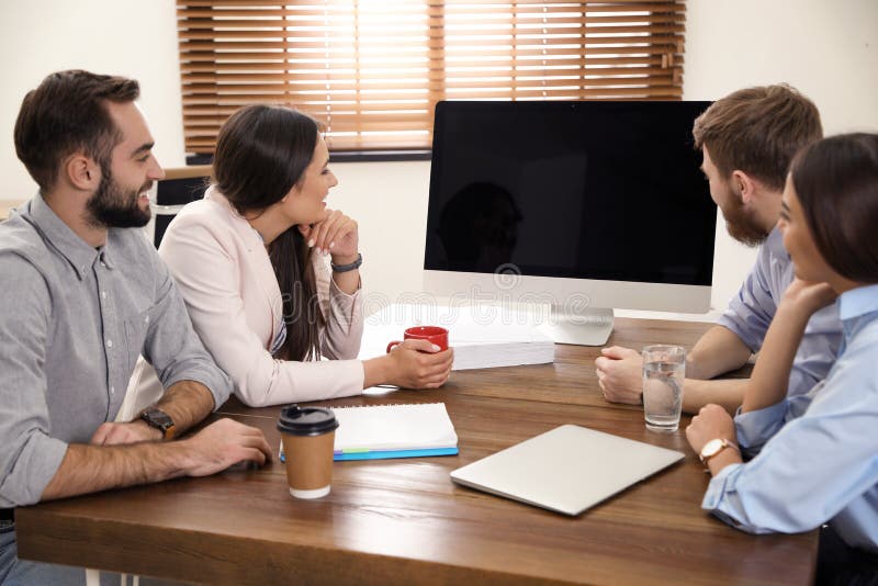 Group of Colleagues Using Video Chat on Computer in Office Stock Image ...