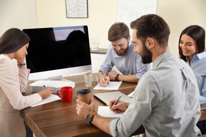 Group of Colleagues Using Video Chat on Computer in Office Stock Photo ...
