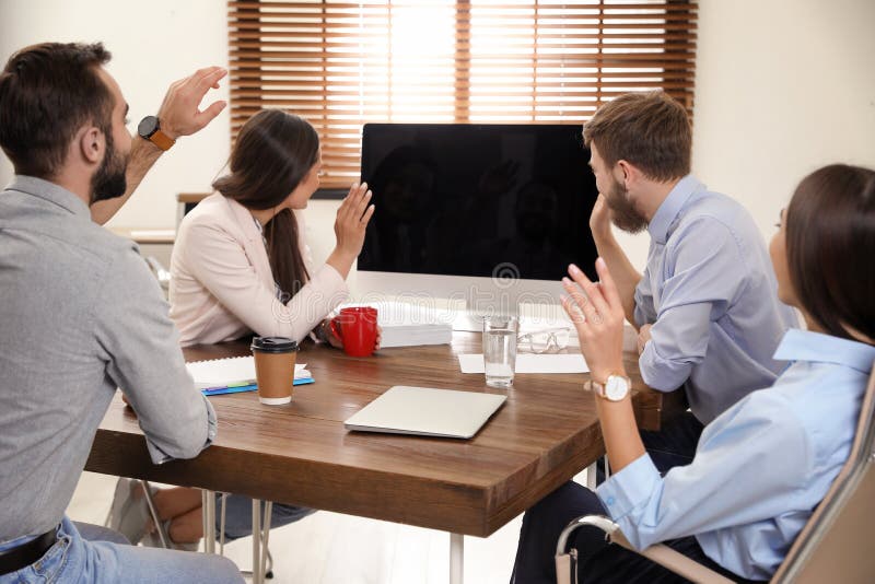 Group of Colleagues Using Video Chat on Computer in Office Stock Image ...