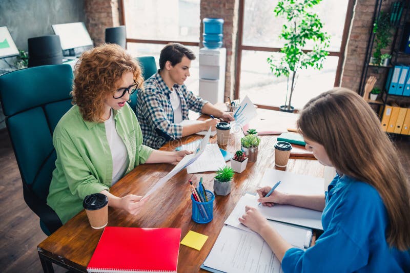 Group of Colleagues Working Together at an Office, Collaborating on ...
