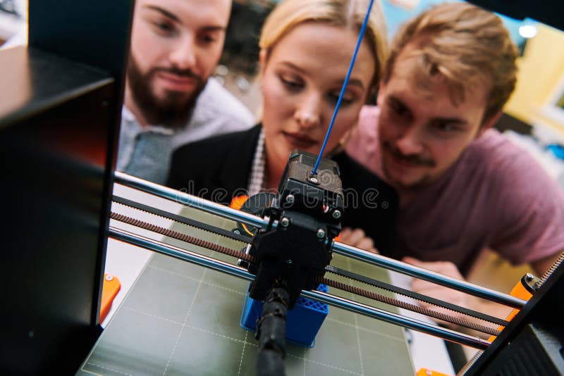 A Group of Colleagues Working Together in a Robotics Laboratory ...