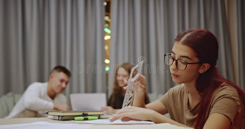 A Group of College Students Study Geometry Together. they are Working ...