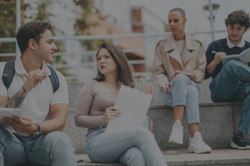 Group of Students Studying Together in an Urban Setting after Class ...