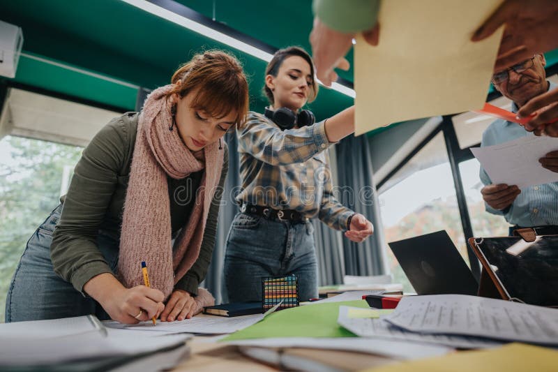 College Students Collaborating with Professor in Modern Classroom ...