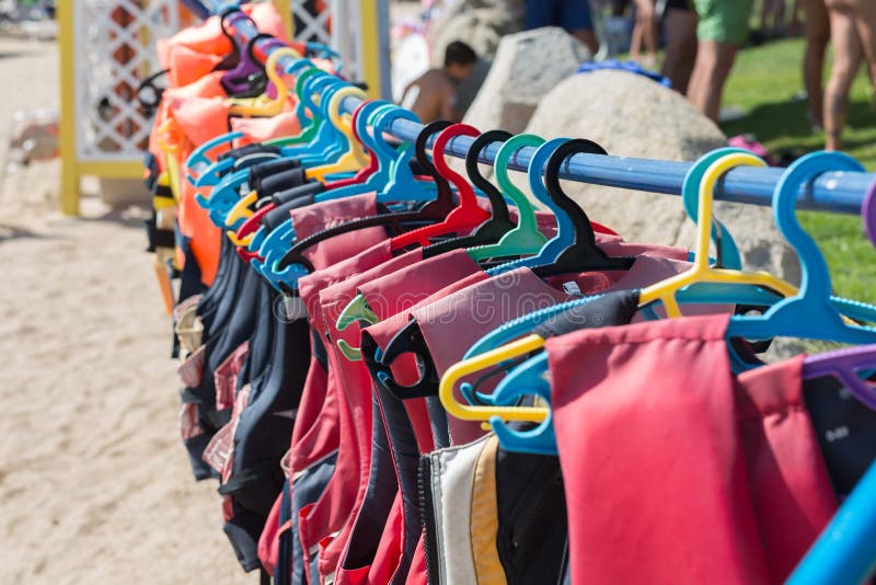Group of Colorful Life Jackets Near the Sea on the Beach Stock Image ...