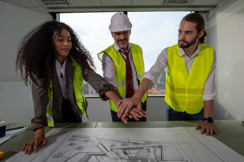 Group of Construction Engineers Touching and Stacking Hands Supporting ...