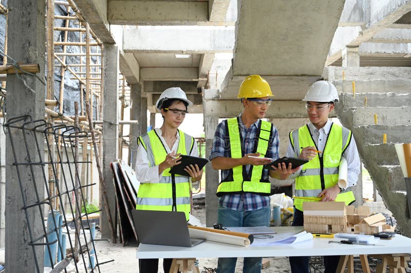 Group of Construction Professionals Wearing Safety Helmets in a ...