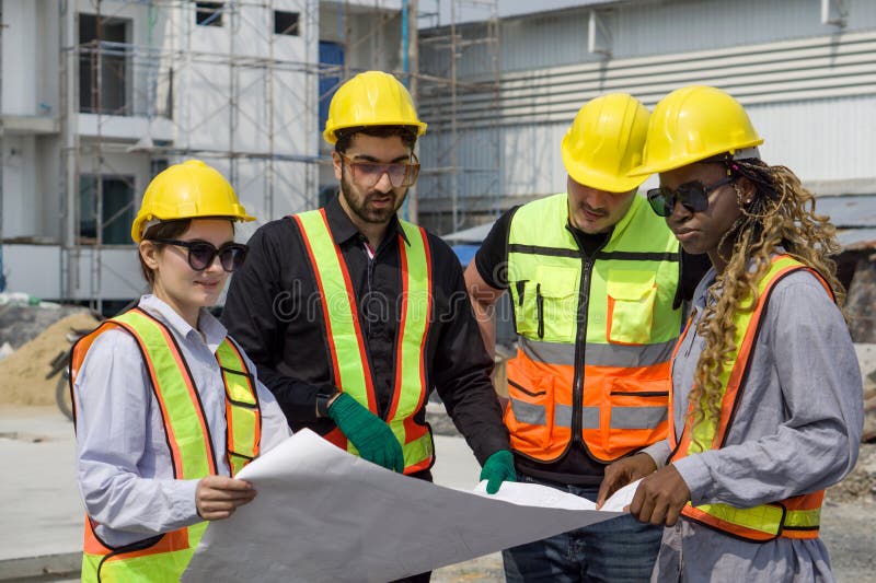 Group of Construction Worker Gathered at a Construction Site Reviewing ...