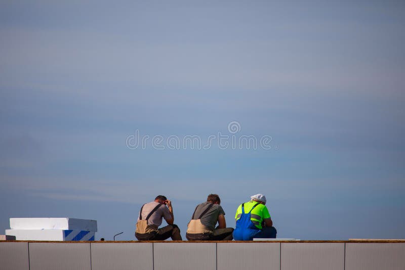 Group of Construction Workers on a Break Stock Image - Image of three ...