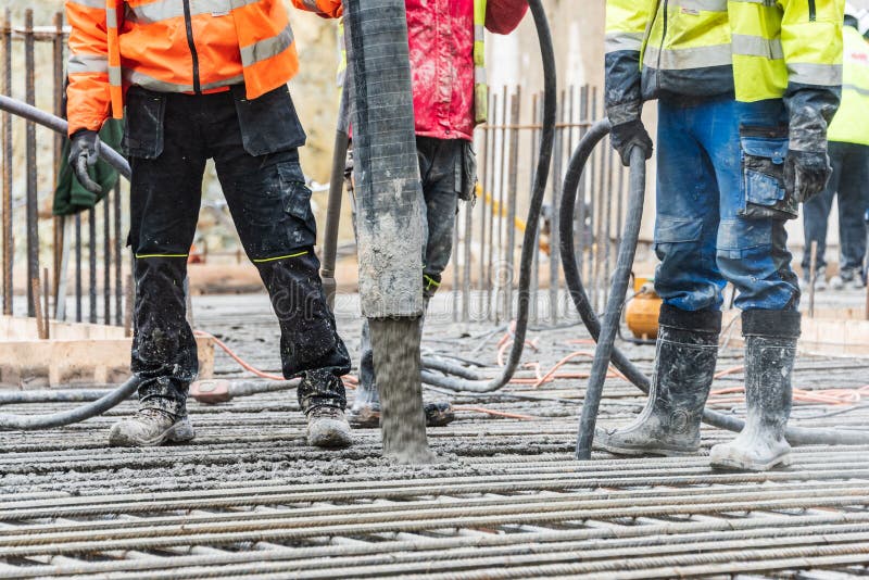 A Group of Construction Workers during Concrete Casting Work Using ...