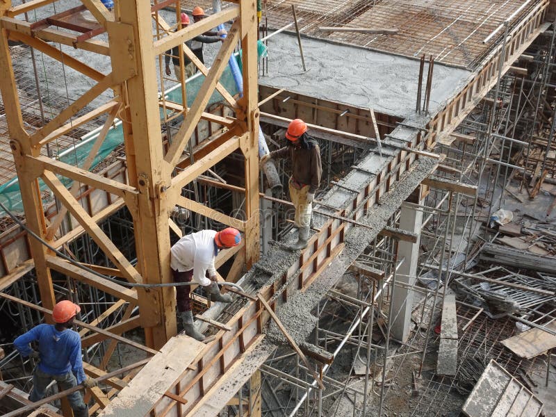 Group of Construction Workers Pouring Wet Concrete Using the Concrete ...