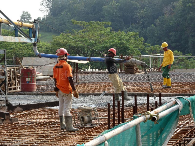 Group of Construction Workers Pouring Wet Concrete Using the Concrete ...