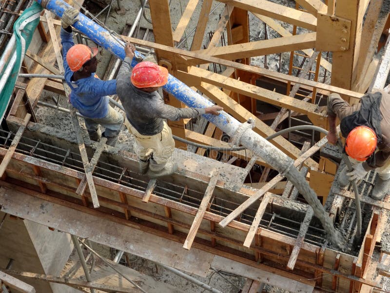 Group of Construction Workers Pouring Wet Concrete Using the Concrete ...