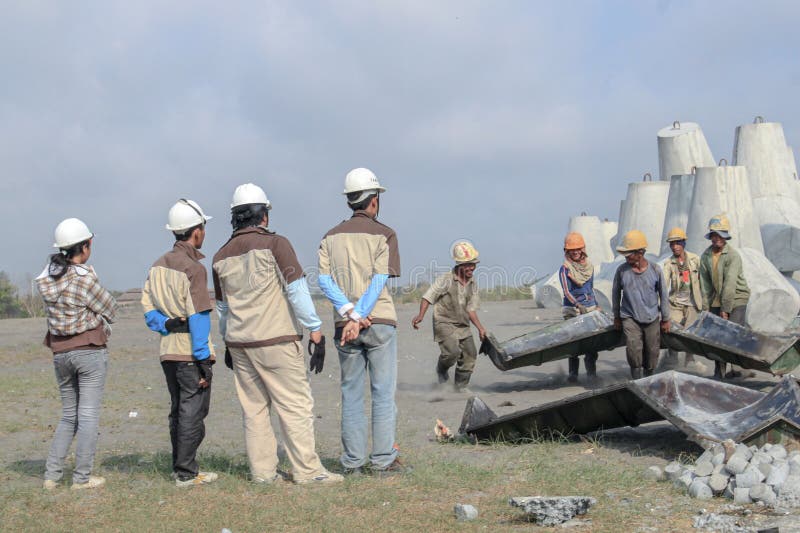 Construction Workers Monitoring Wave Breaker Installation at Glagah ...